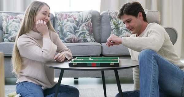 Love, couple and board game together on floor in living room for happy ...