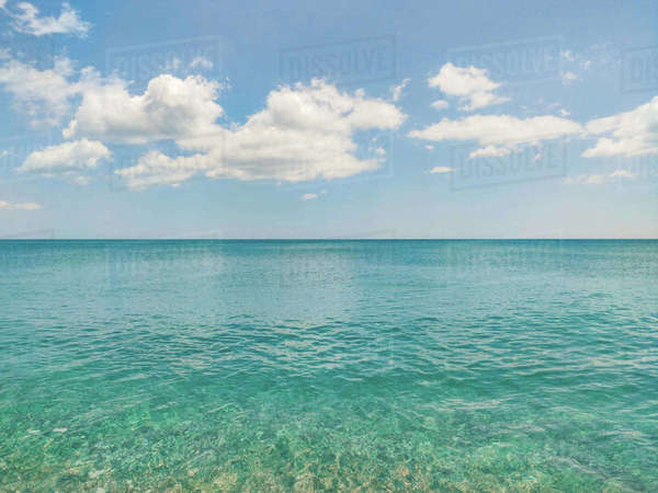 Calm Ocean Horizon with clouds. - Royalty-free Stock Photo | Dissolve