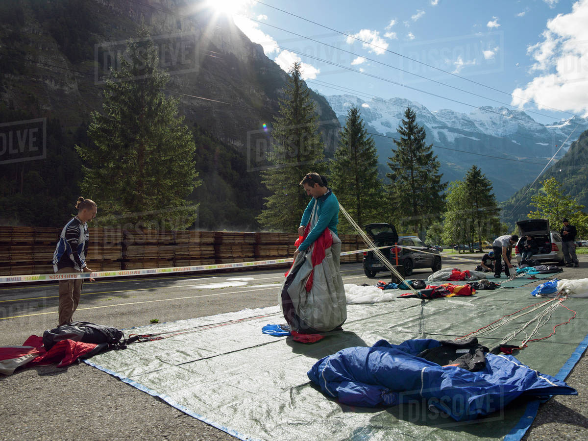 Man folding the parachute after skydiving - Royalty-free Stock Photo ...