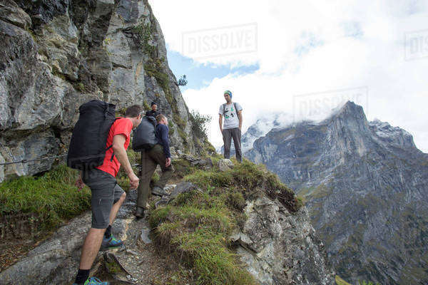 Hikers walking up on a path in the mountains - Royalty-free Stock Photo ...