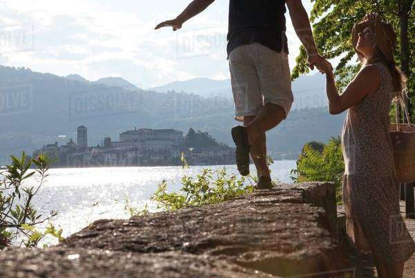Man walking along a ledge - Royalty-free Stock Photo | Dissolve