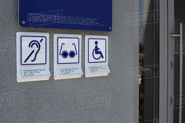 Set of symbols with braille text on special sign near the entrance to ...