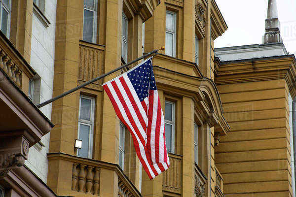 Striped American flag with symbols of all states in form of stars flies ...