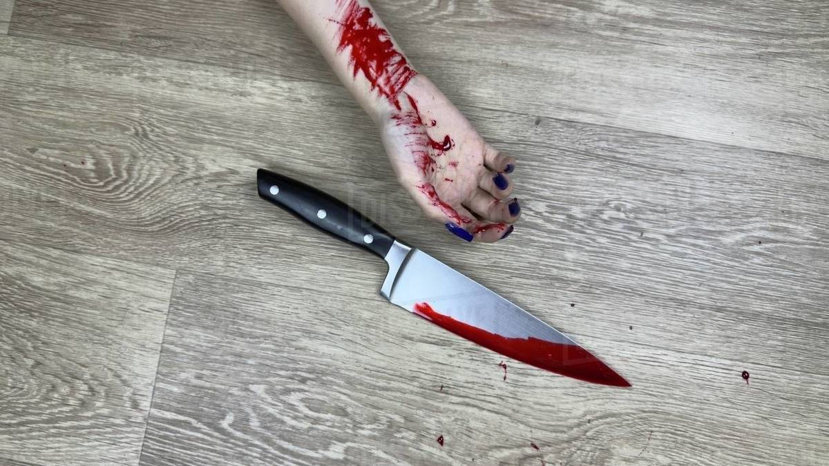 Crime scene with knife covered in blood and victim bloody hand on floor ...