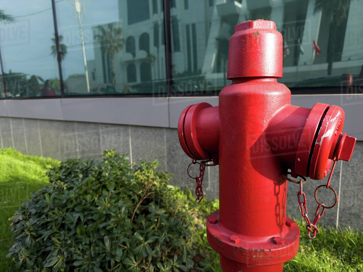 Fire hydrant on street near building in city. Firefighting safety ...