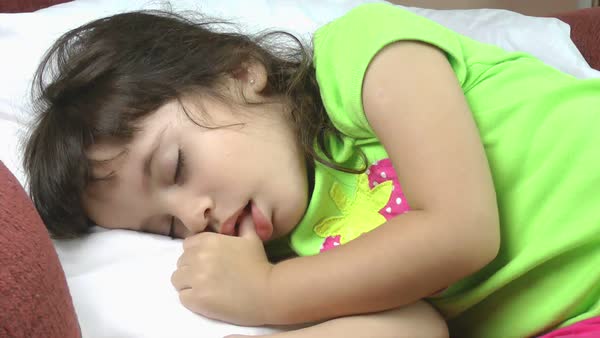 Little girl snoring, laying on bed - Stock Video Footage - Dissolve