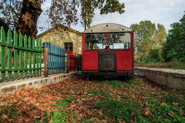 Deserted train station with multi-color painted wooden railings and old ...