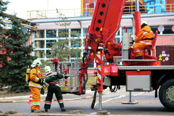 Firefighter rescuers at work in fireproof suits came to extinguish a ...