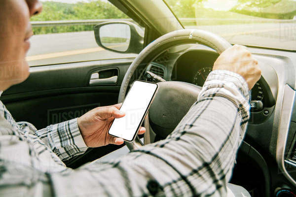 Man using his phone while driving, Person holding the cell phone and ...