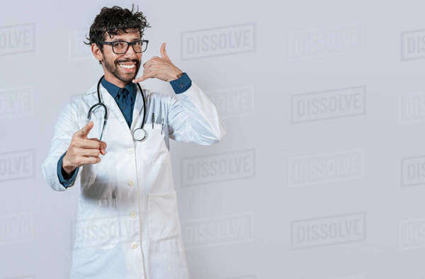 Young doctor making call gesture isolated. Smiling doctor making call ...