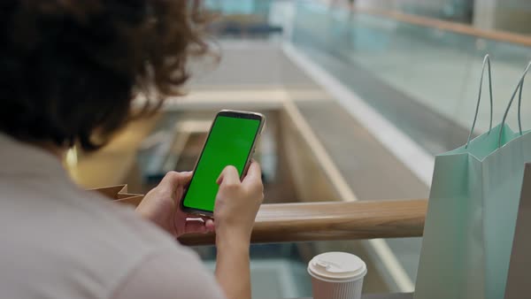 Client, business owner Looking at the green screen of the smartphone ...