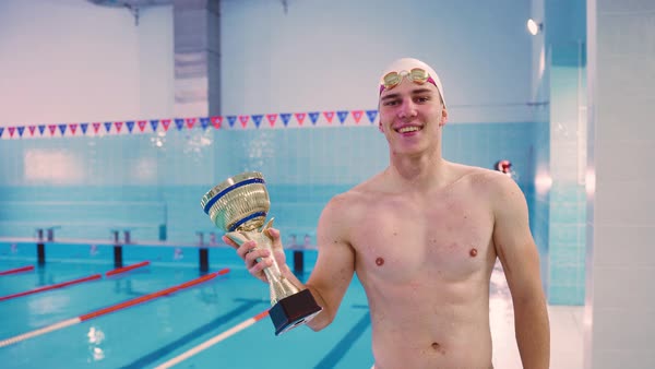 Portrait of a winning professional muscular athlete swimmer after a ...