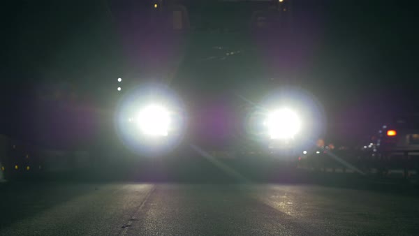 Bus headlights lens flare on highway - Stock Video Footage - Dissolve