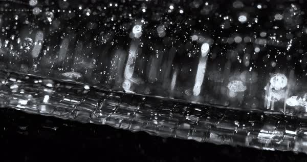 Clear gel substance flowing and reflecting lights in bubbles. Macro ...