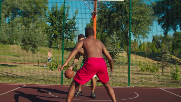 Two shirtless muscular build african american street basketball players ...