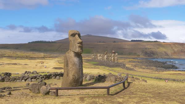 AERIAL, COPY SPACE: Flying around a large moai sculpture on a remote ...