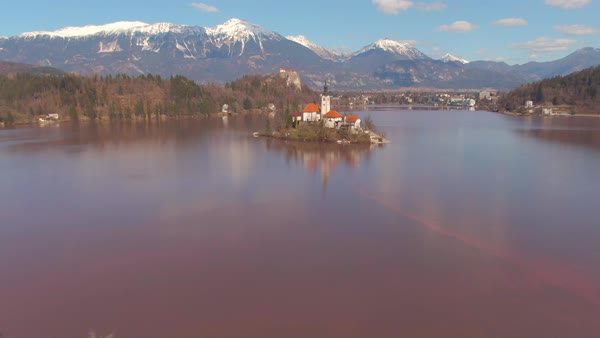 AERIAL: Flying above the famous lake Bled in Slovenia surrounded by red ...