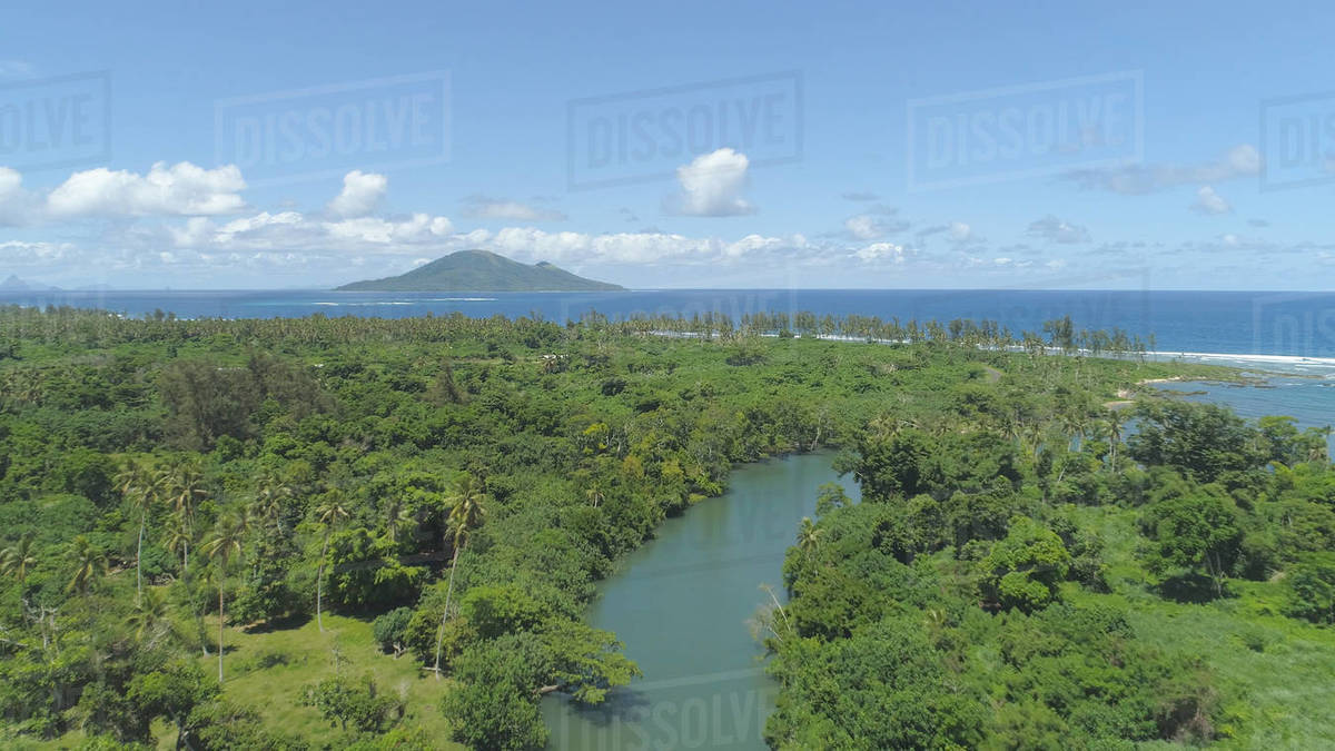 AERIAL: Flying along tropical river estuary and towards distant ...
