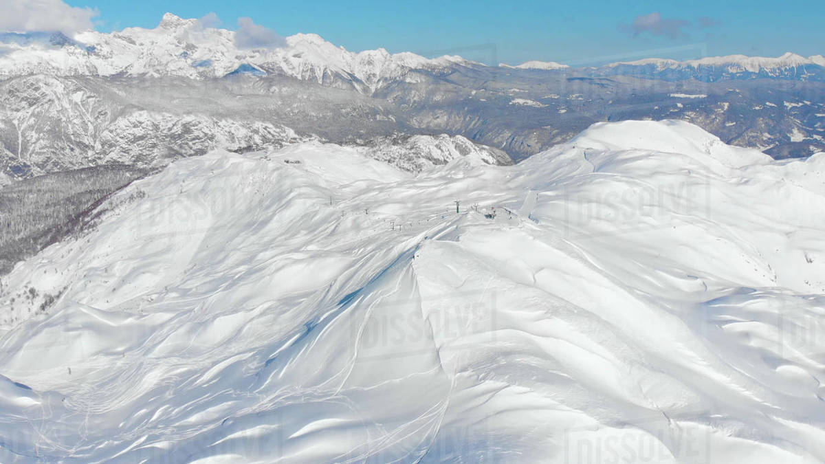 AERIAL: Flying towards the slopes of a ski resort in the spectacular ...