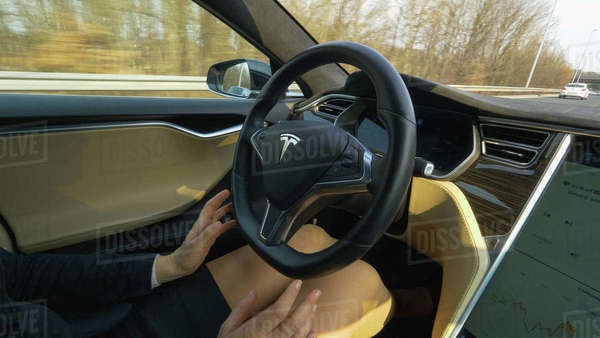 AUTONOMOUS TESLA CAR, MARCH 2018 - CLOSE UP: Well dressed woman lifts ...