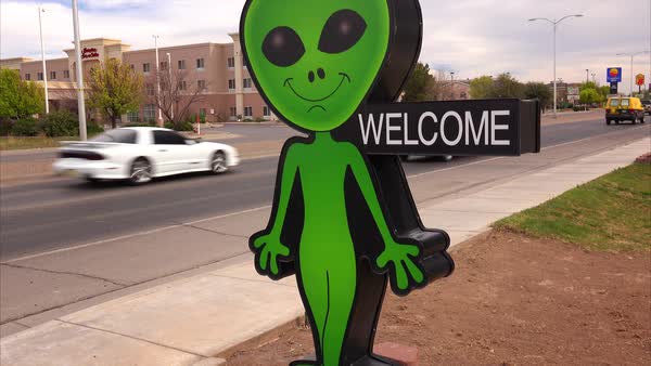 Little green alien and welcome sign welcomes visitors to a business in ...
