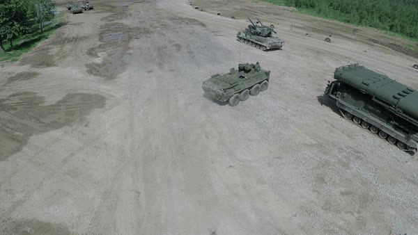 Aerial view of tanks and missile launcher gathering together on firing ...