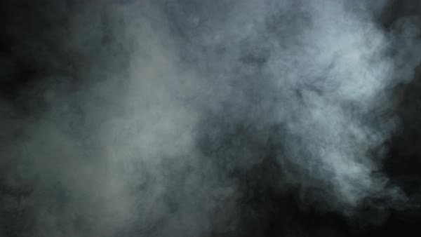 Realistic smoke / fog moving in the ray of light on black background ...