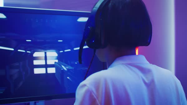 Professional gamer playing in first-person shooter online video game on ...