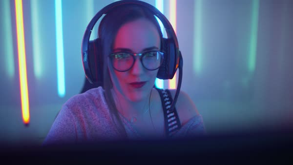 Beautiful professional gamer girl sitting down to playing in online ...