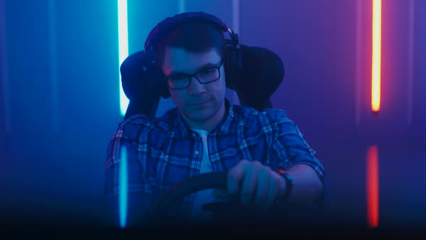 Portrait of the pro gamer sitting in the racing seat simulator cockpit ...