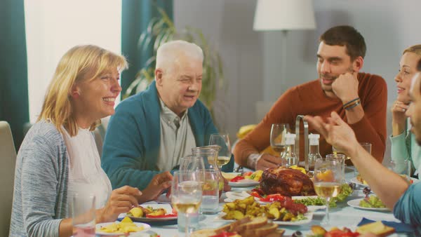 Family and Friends Gathering at the Dining Table. Senior Couple Talking ...