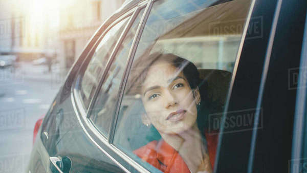 Beautiful Sad Woman Rides on a Passenger Back Seat of a Car, Looks out ...