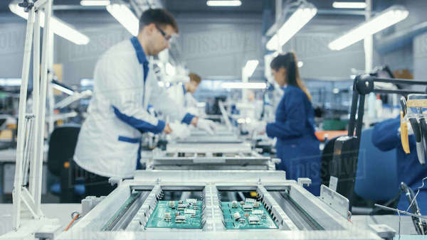 Shot of an Electronics Factory Workers Assembling Circuit Boards by ...