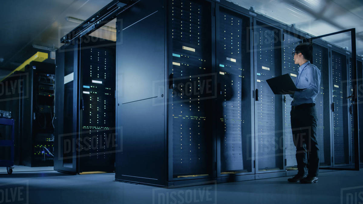 In Data Center: Male IT Technician Running Maintenance Programme on a ...