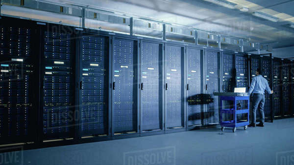In the Modern Data Center: IT Engineer Doing Maintenance and ...