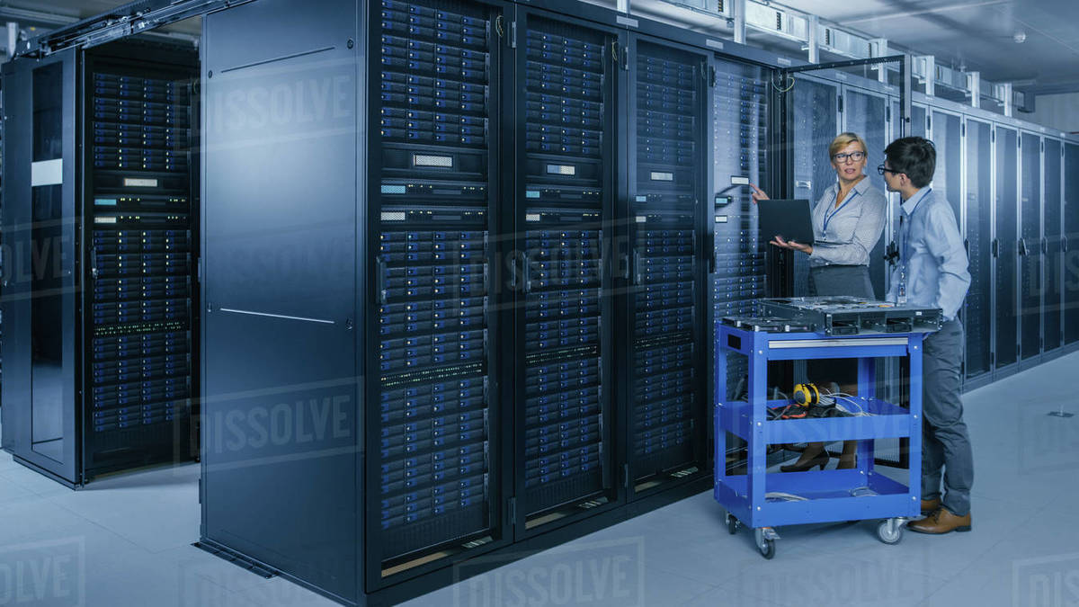 In the Modern Data Center: Engineer and IT Specialist Work with Server ...
