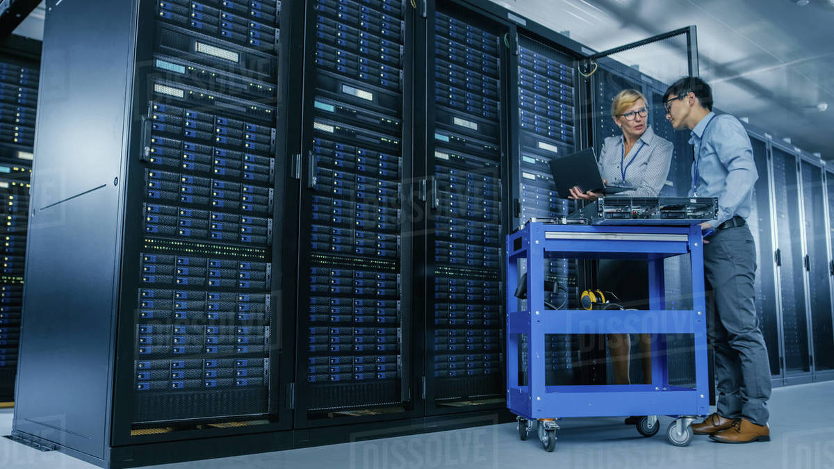 In the Modern Data Center: Engineer and IT Specialist Work with Server ...