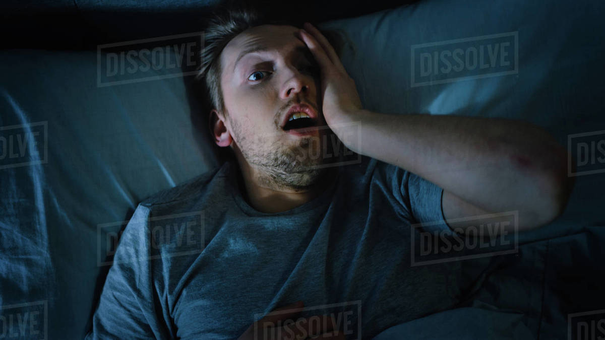 Top View of a Young Man in Bed at Night Having Terrible Nightmare, He ...