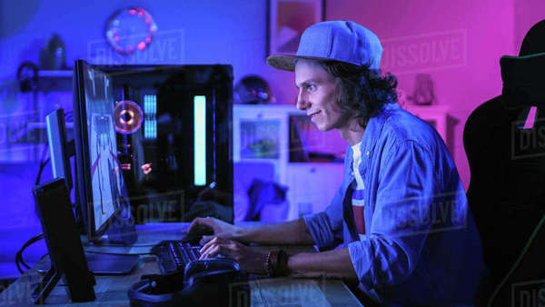 Professional gamer playing first-person shooter online video game on ...