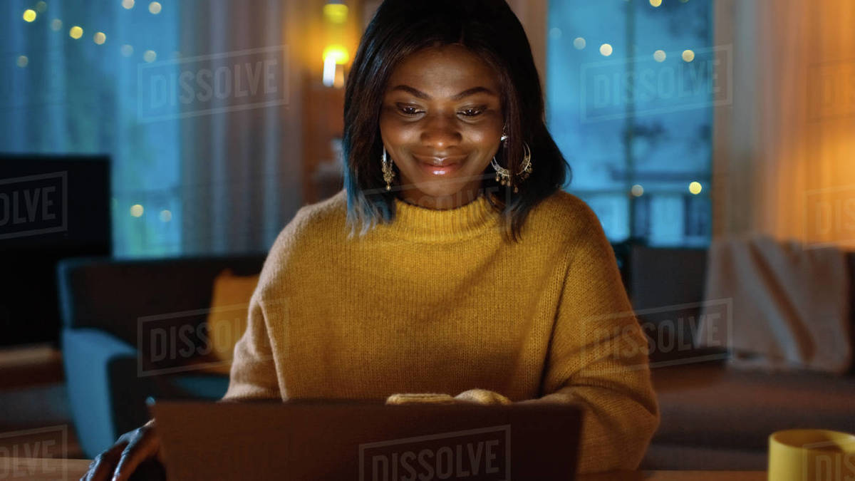 Portrait of Beautiful Smiling Black Girl Working on a Laptop while ...