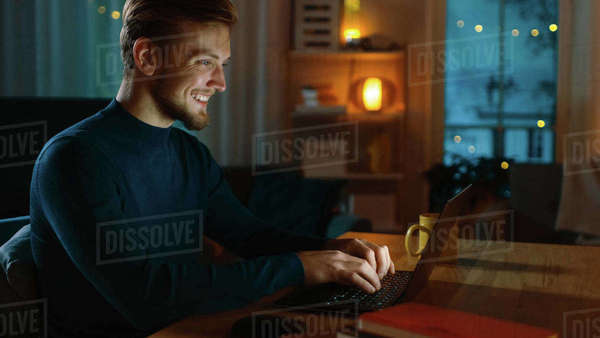 Evening at Home: Portrait of Handsome Man Sitting at His Desk Working ...