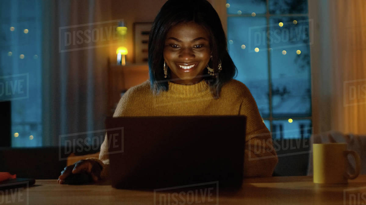 Portrait of Beautiful Smiling Black Girl Working on a Laptop while ...