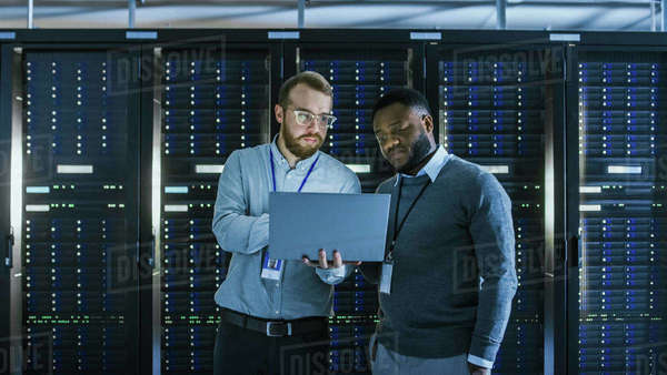 Bearded IT Technician in Glasses with a Laptop Computer and Black Male ...