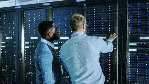 Bearded IT Technician in Glasses with a Laptop Computer and Black Male ...