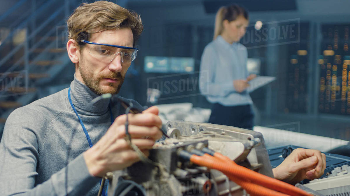 Professional Automotive Engineer in Glasses with a Computer and ...