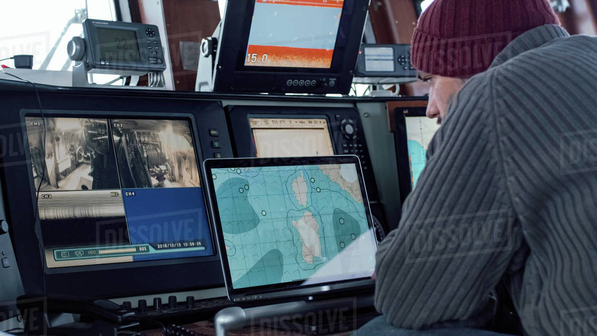 Captain of Commercial Fishing Ship Surrounded by Monitors and Screens ...