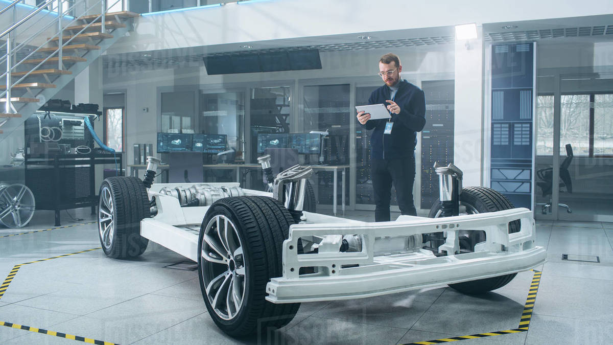 Engineer with Glasses and Beard Scans Electric Car Chassis Prototype ...