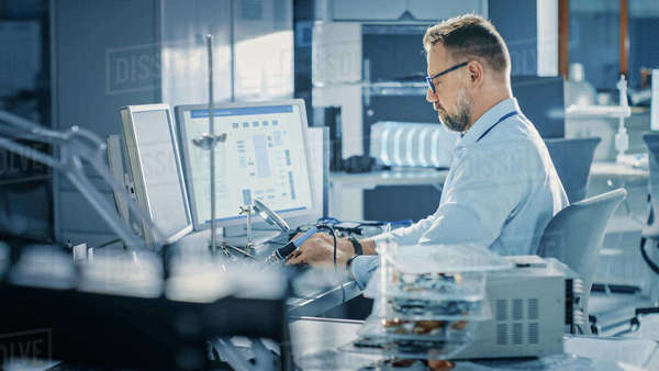 Electronics Development Engineer Working on Computer, Designing ...