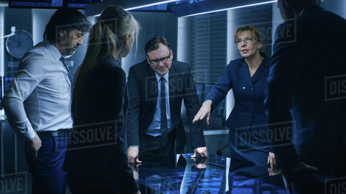 Diverse Team of Government Intelligence Agents Standing Around Digital ...