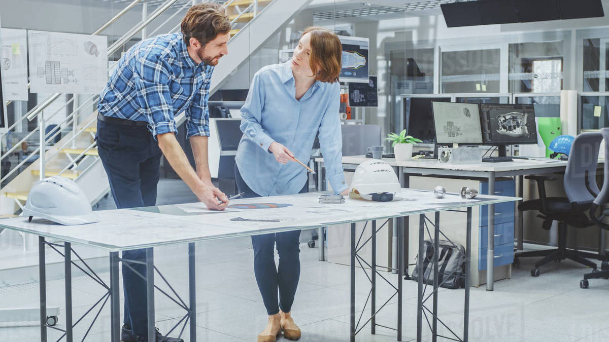 In Engineering Agency: Female Engineer and Male Technician Working on ...